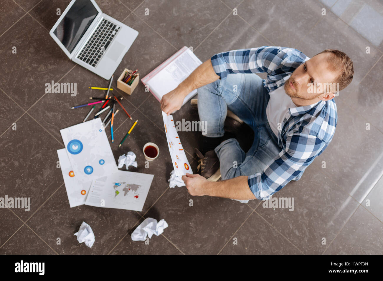 Thoughtful handsome man holding a drawing Stock Photo - Alamy