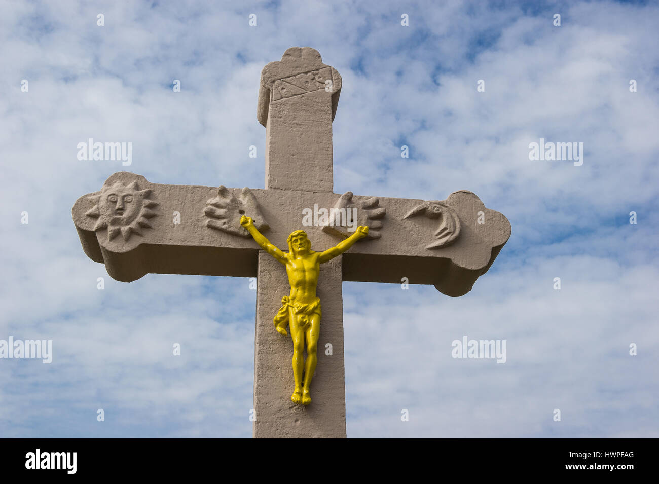 christian cross with yellow jesus statue Stock Photo - Alamy