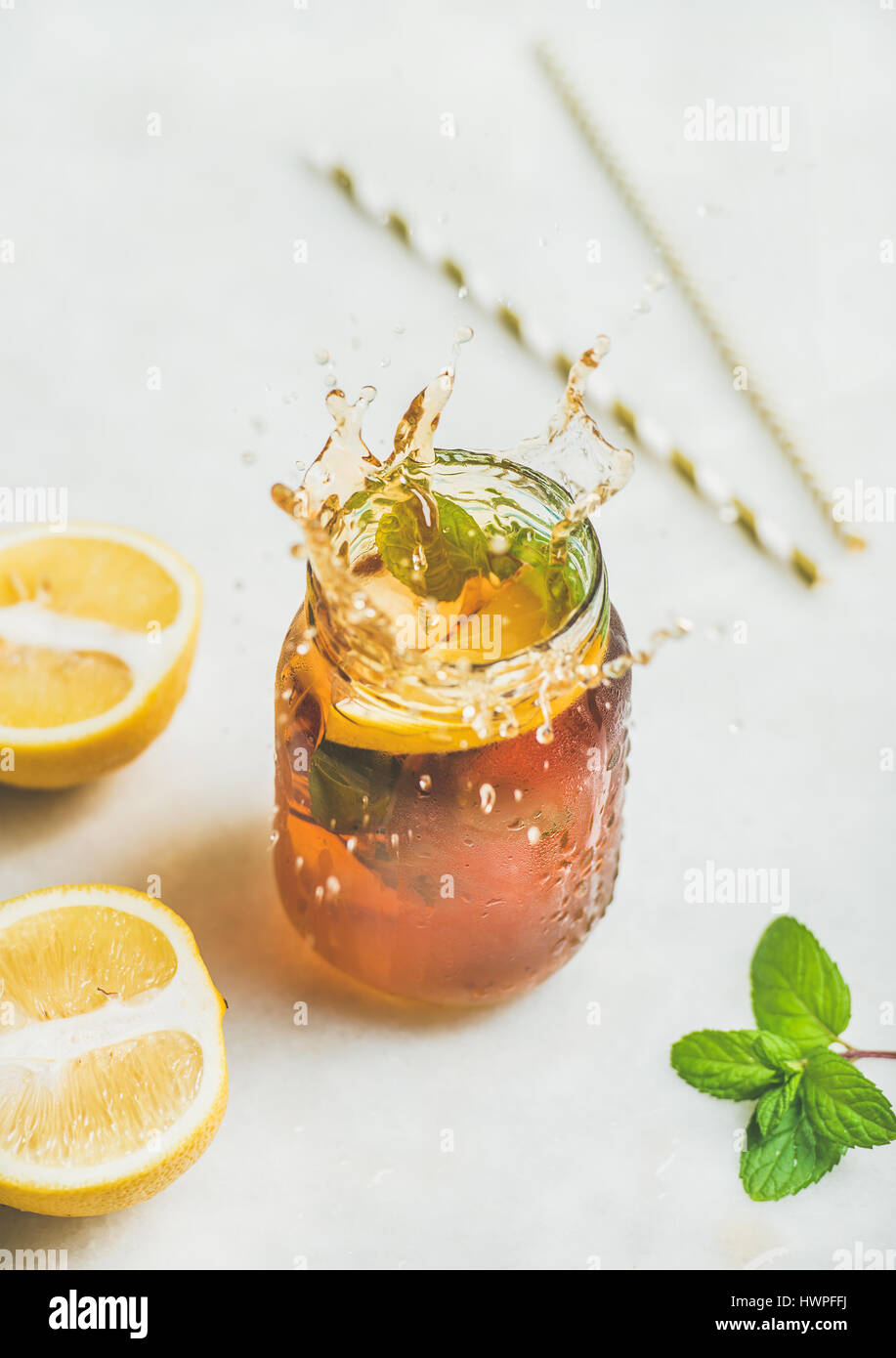 Summer cold Iced tea with lemon and herbs, vertical composition Stock ...
