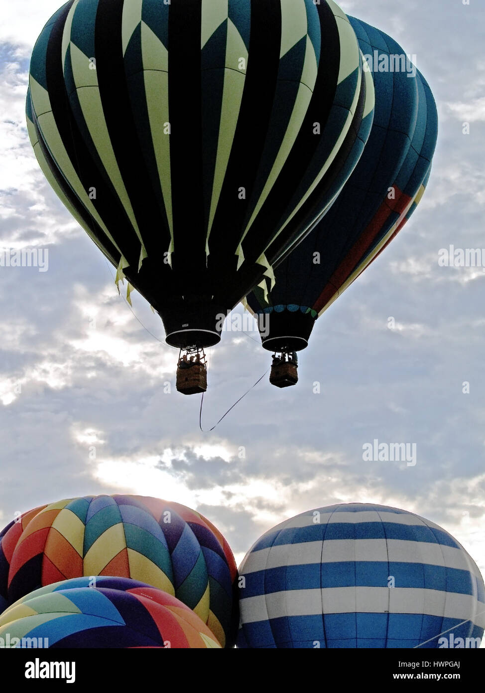 Five hot air balloons take off against a cloudy sky Stock Photo - Alamy