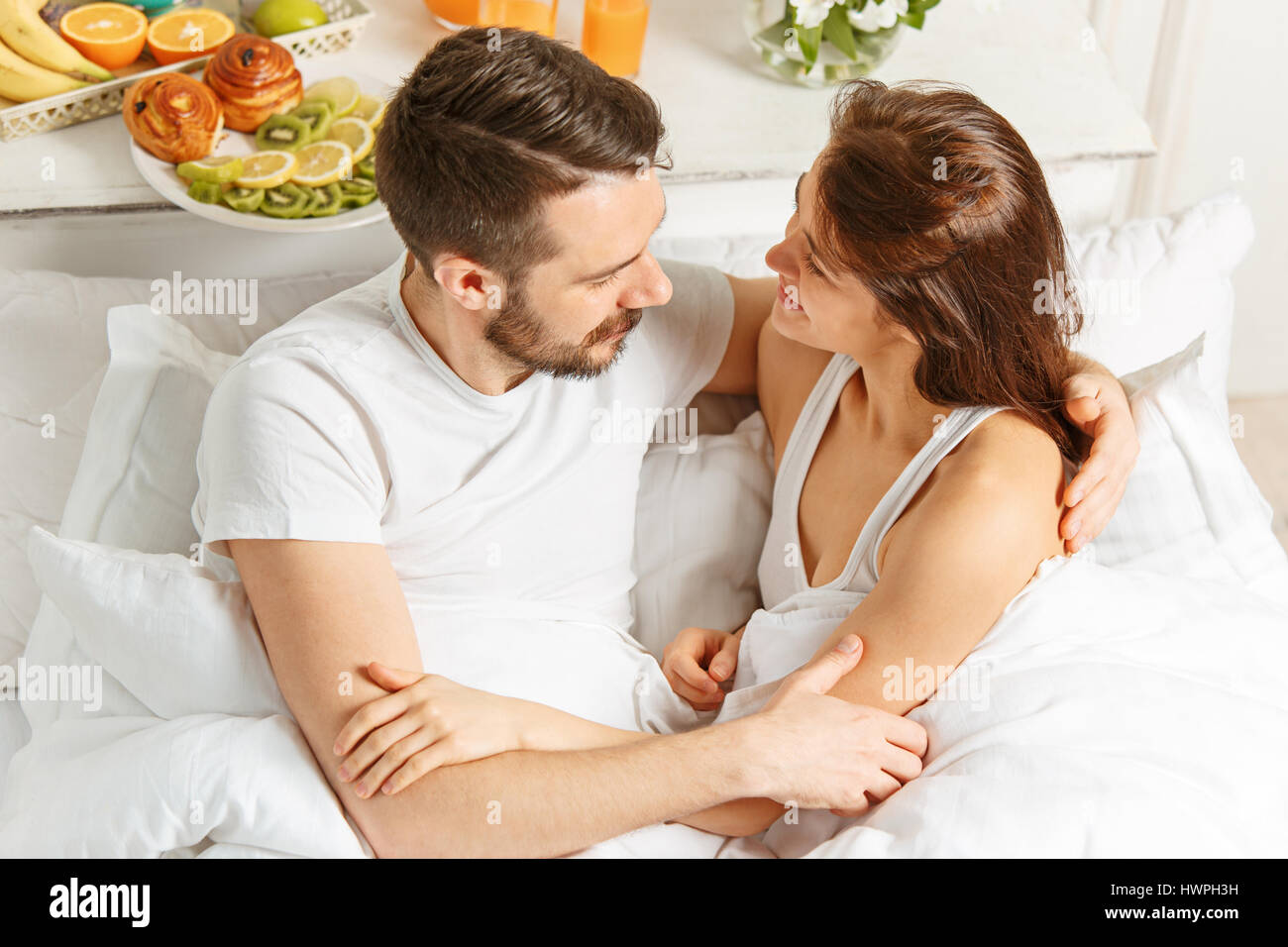 Relaxed Couple in Bed in bedroom at home Stock Photo - Alamy