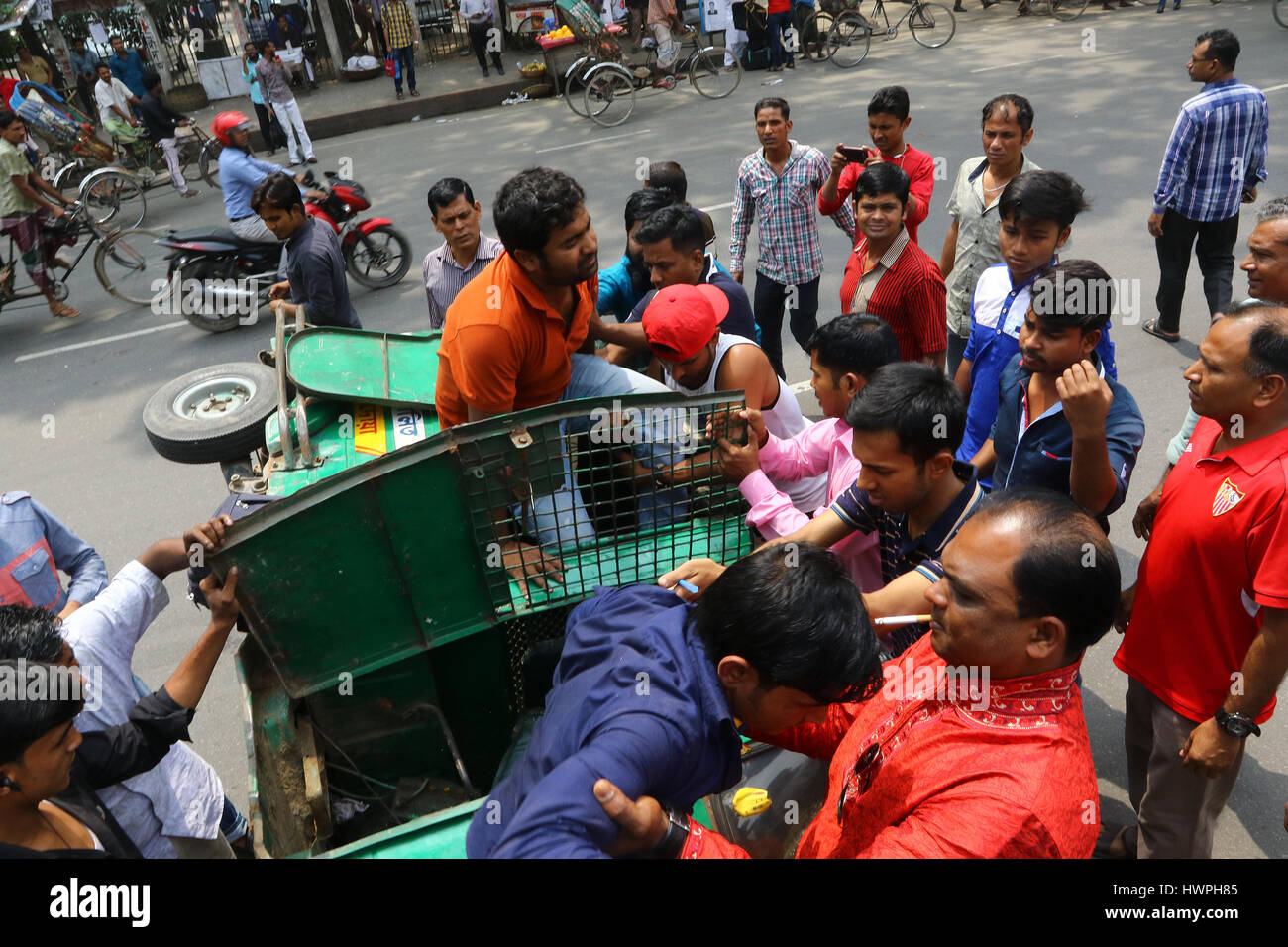 Dhaka 19 march 2017. Onlookers rescue the driver and passengers of a ...