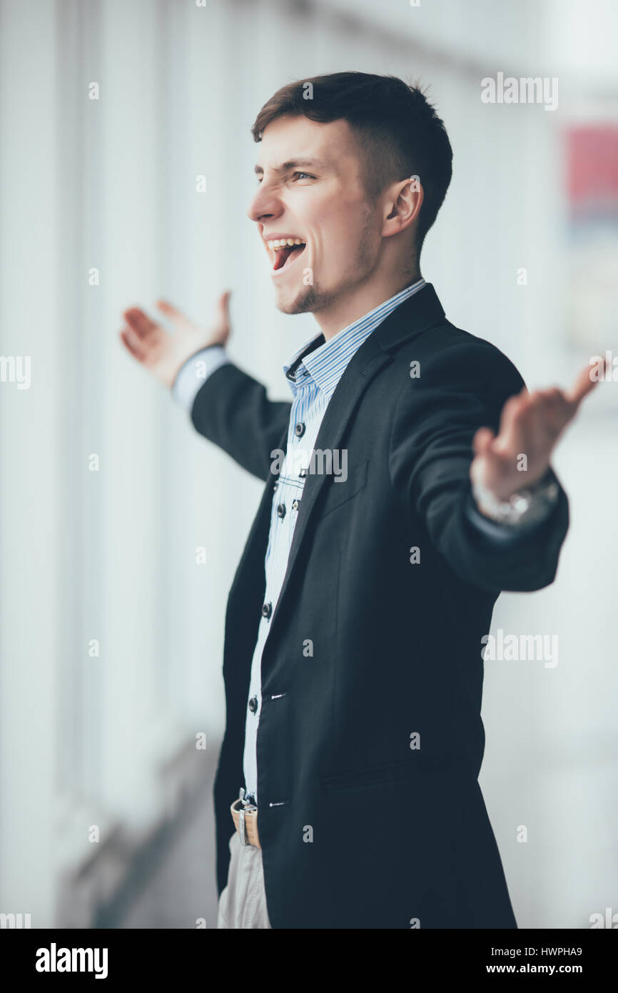 Business man with rised hands in his office Stock Photo - Alamy