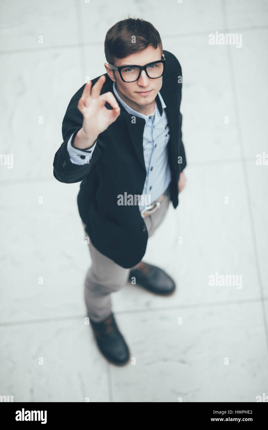 Young and beautiful businessman making ok sign . Top view Stock Photo ...