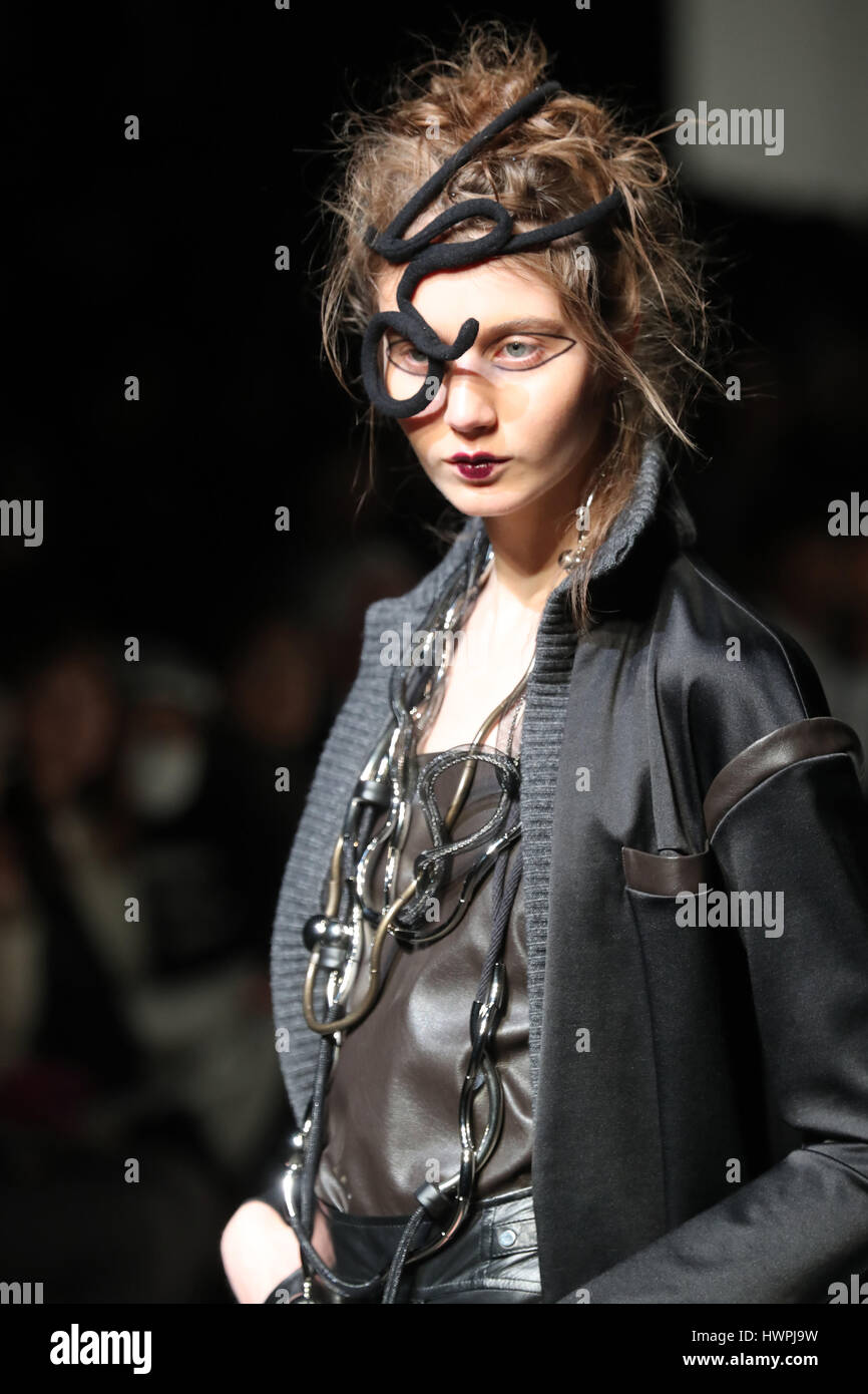 Tokyo, Japan. 21st Mar, 2017. A model displays a creation designed by ...