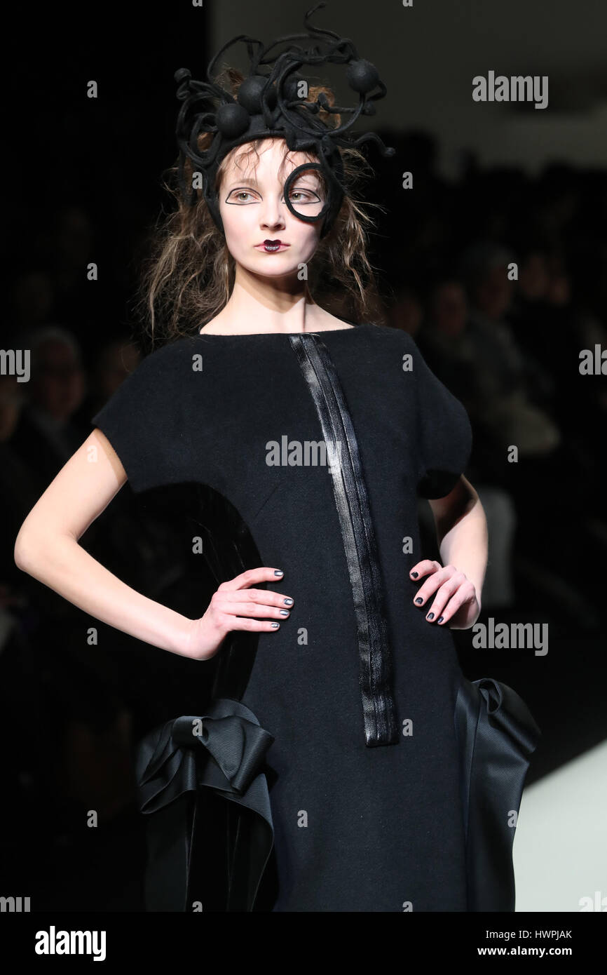 Tokyo, Japan. 21st Mar, 2017. A model displays a creation designed by ...