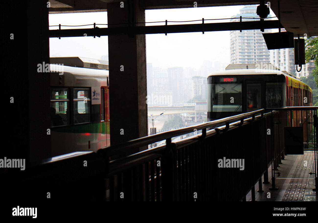 Chongqing, China. 22nd Mar, 2017. The light rail passes through a ...