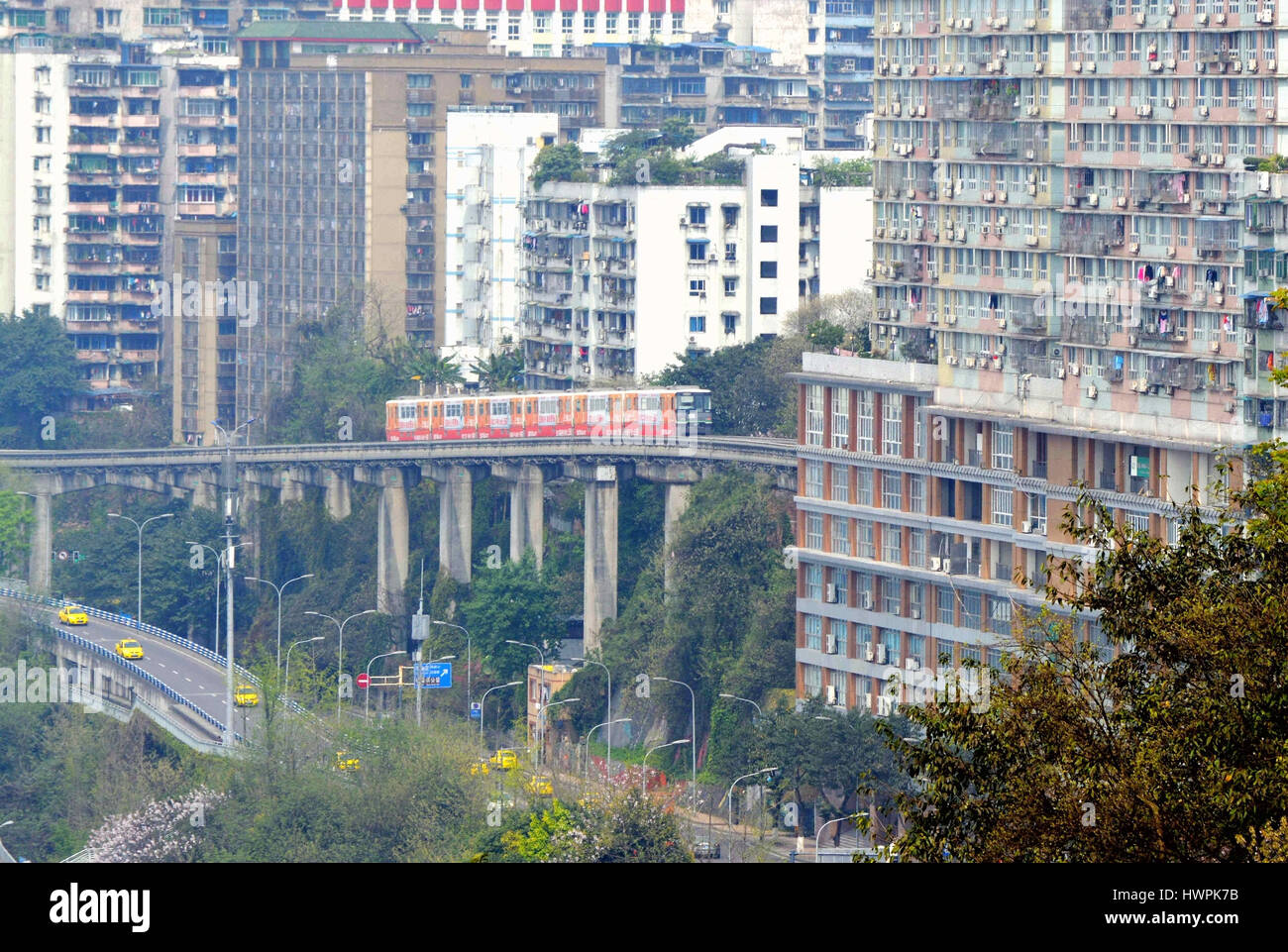 Chongqing, China. 22nd Mar, 2017. The light rail passes through a ...