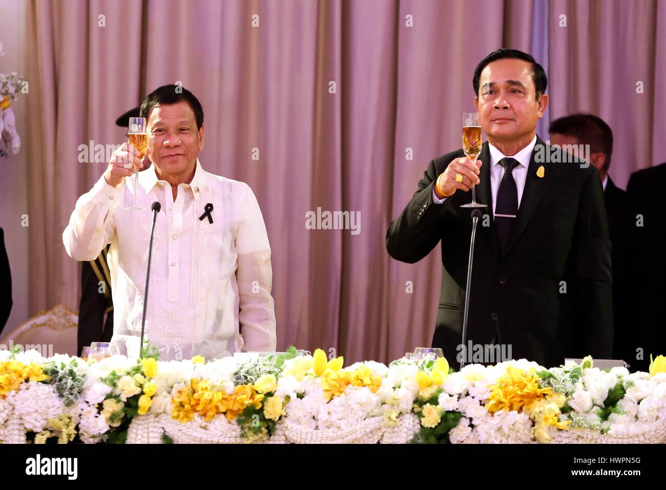Philippine President Rodrigo Duterte, left, holds his glass in a toast ...