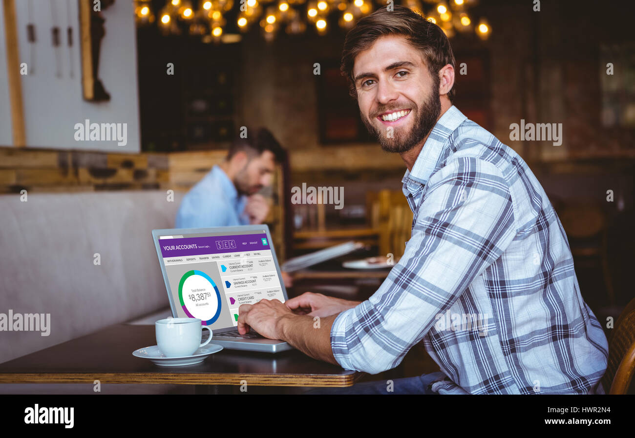 Graphic image of bank account web site against young man working on his ...