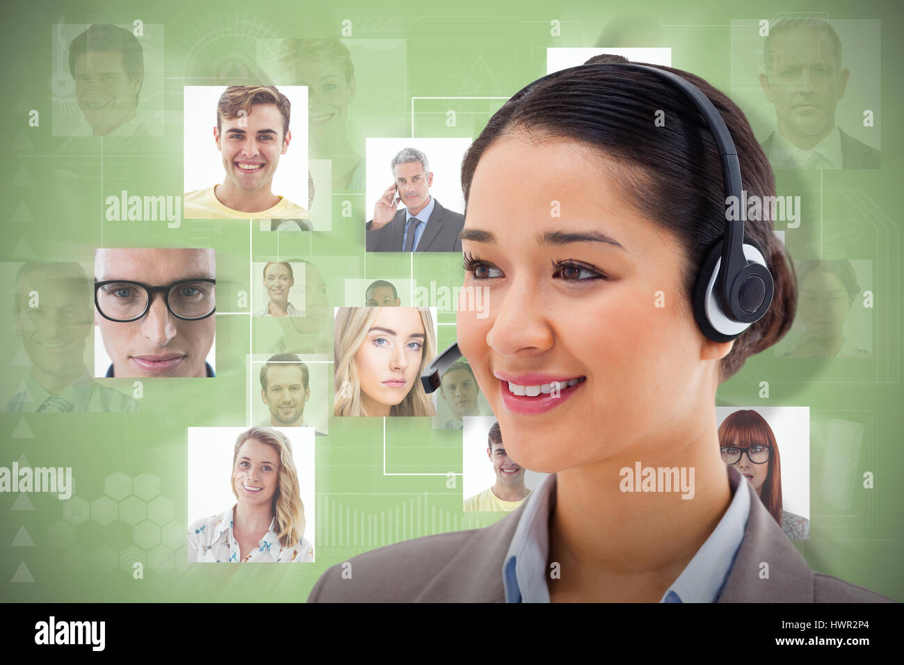 Happy operator posing with a headset against green background Stock ...