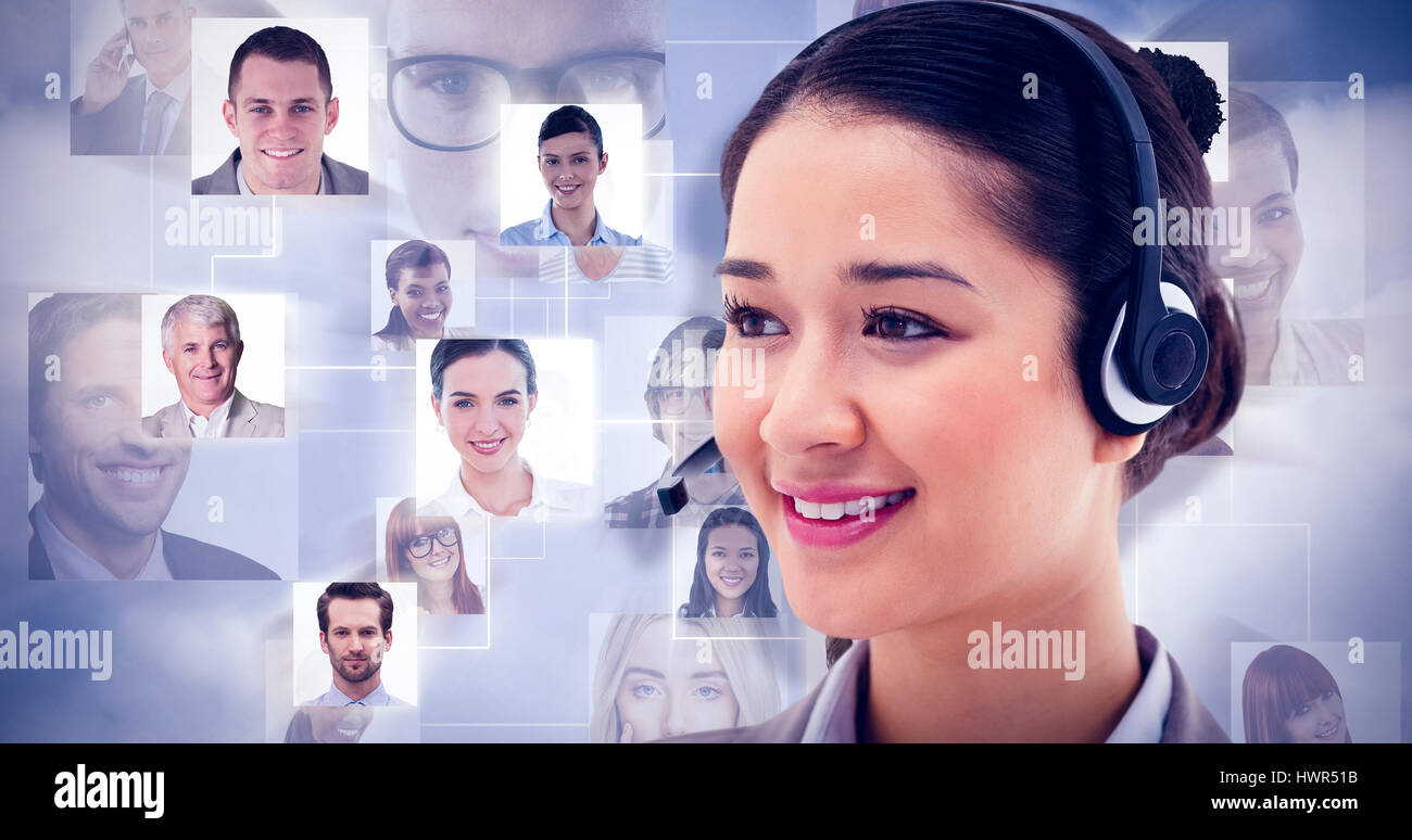 Happy operator posing with a headset against grey background Stock ...