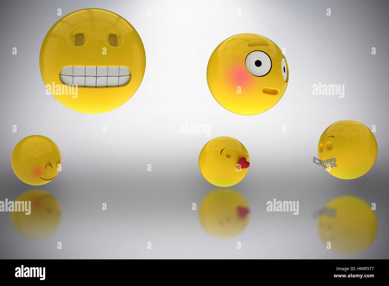 Three dimensional image of various smileys faces reactions against grey ...