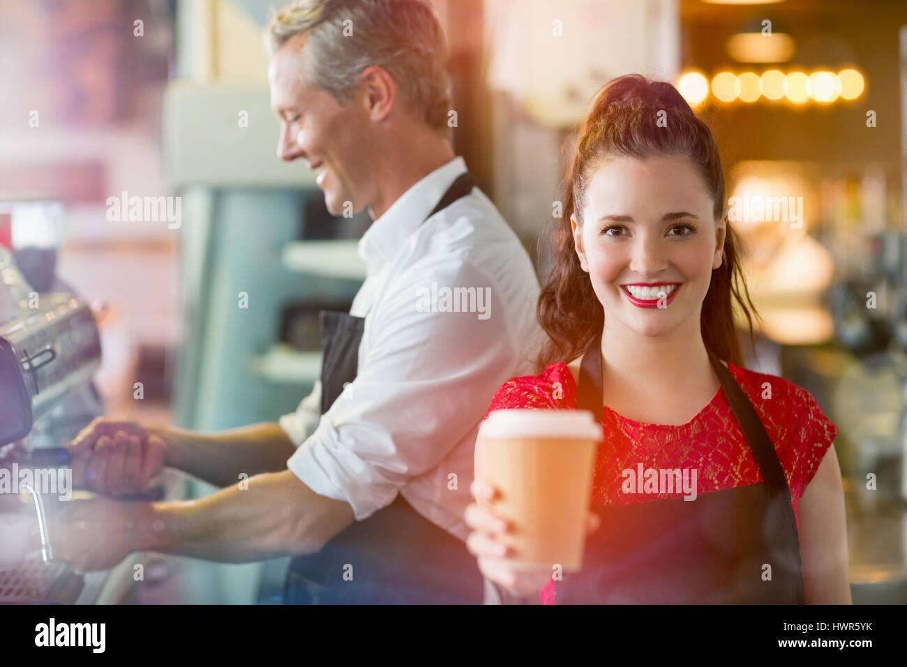 Graphic image of flare against barista offering coffee Stock Photo - Alamy