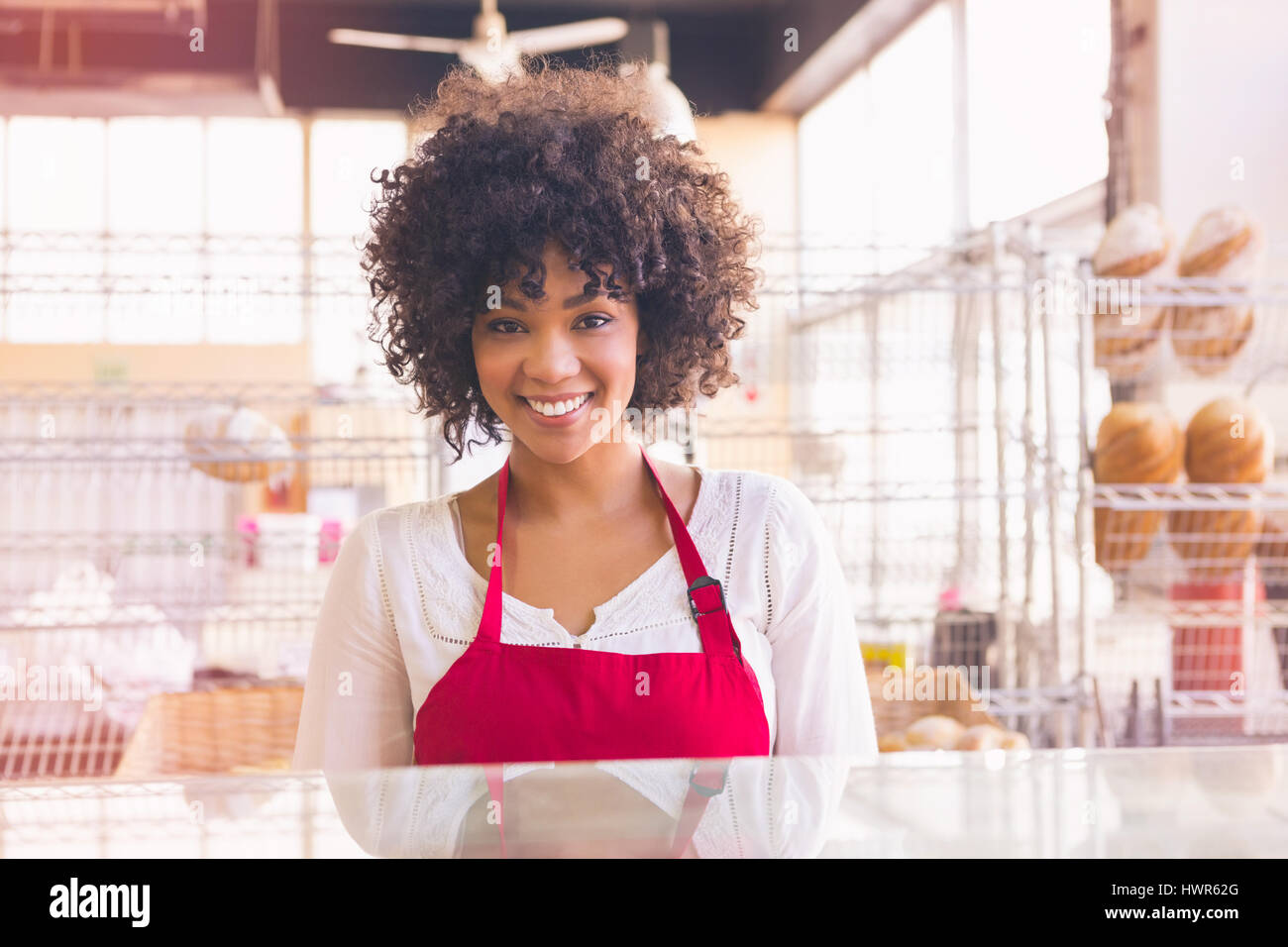 Woman smiling behind bakery counter hi-res stock photography and images ...