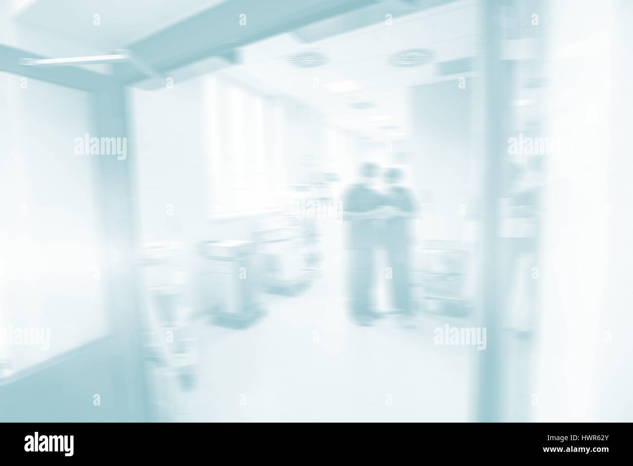 Doctor standing on corridor with open door in hospital Stock Photo - Alamy