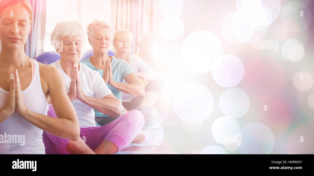 Front view of seniors relaxing with fitness instructor in retirement ...