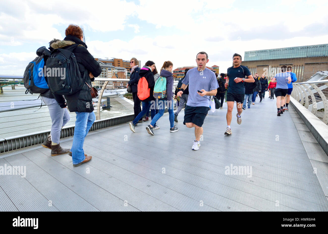 London, England, UK. Runners on the Millennium Bridge, running from ...