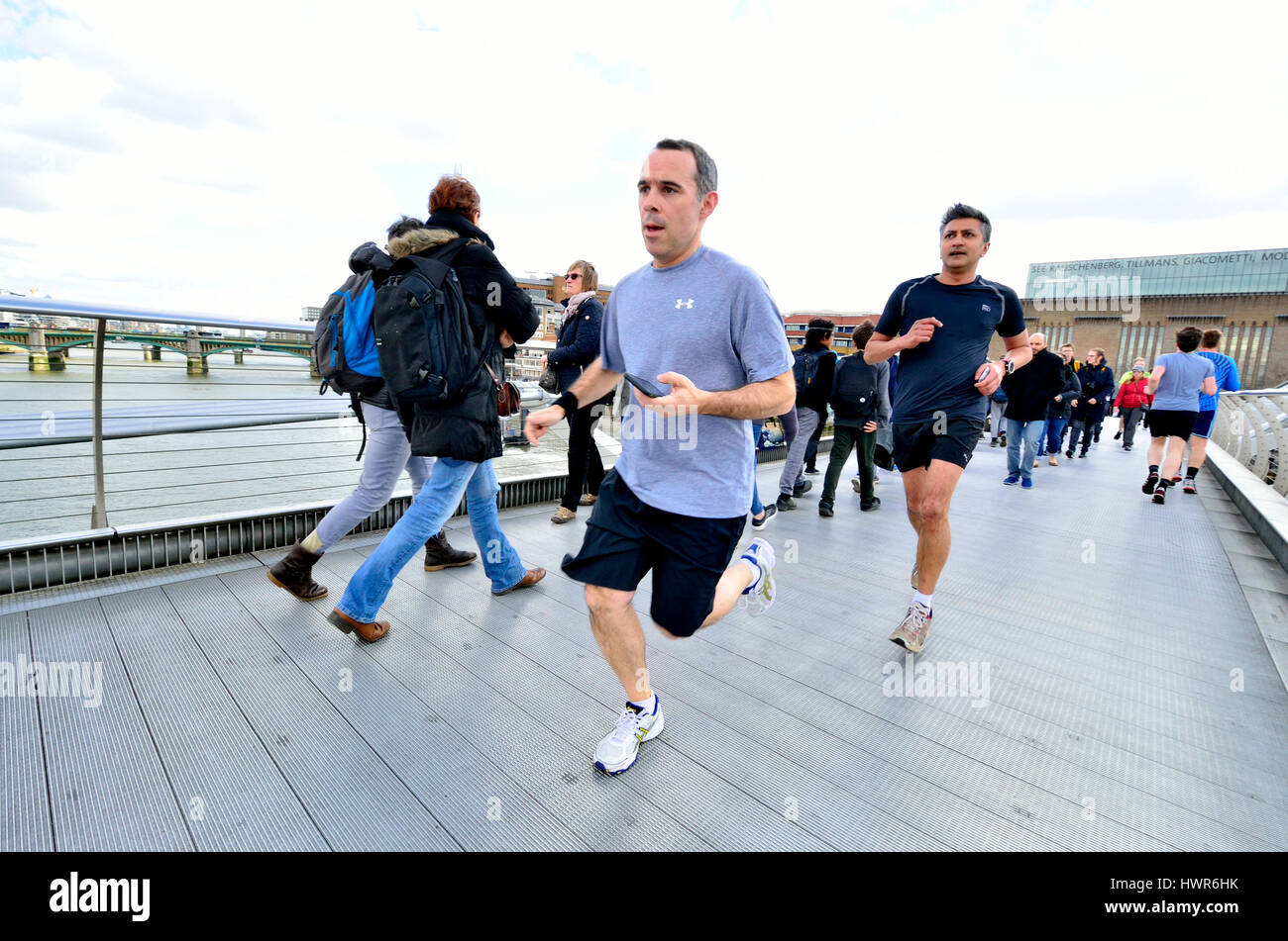 London, England, UK. Runners on the Millennium Bridge, running from ...