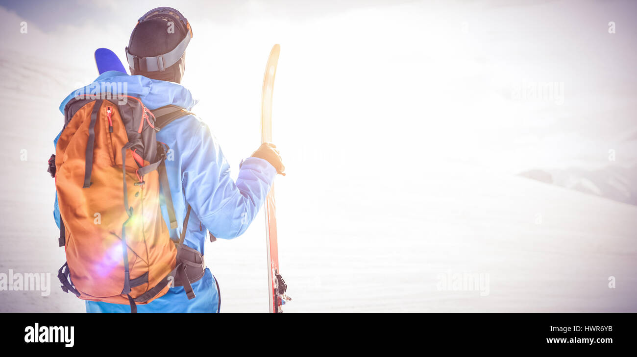 Rear view of skier looking at beautiful snow-covered mountains Stock ...