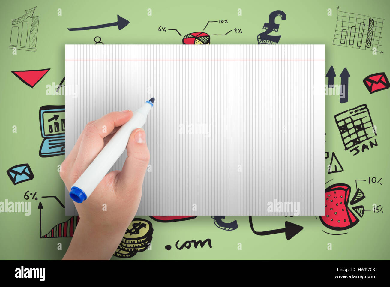Hand holding black crayon against green background Stock Photo - Alamy