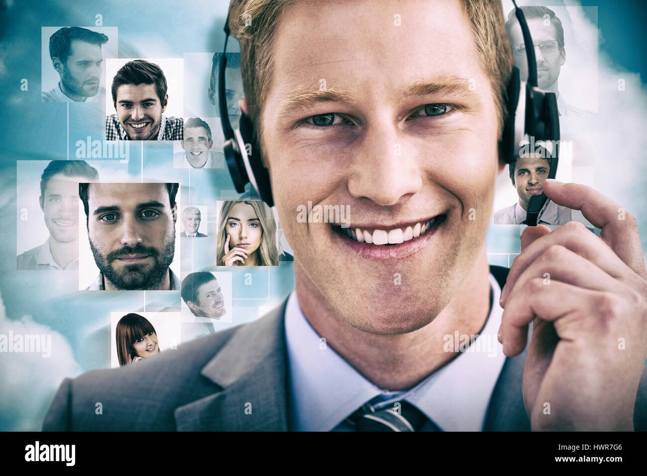 Handsome agent wearing headset against blue background Stock Photo - Alamy