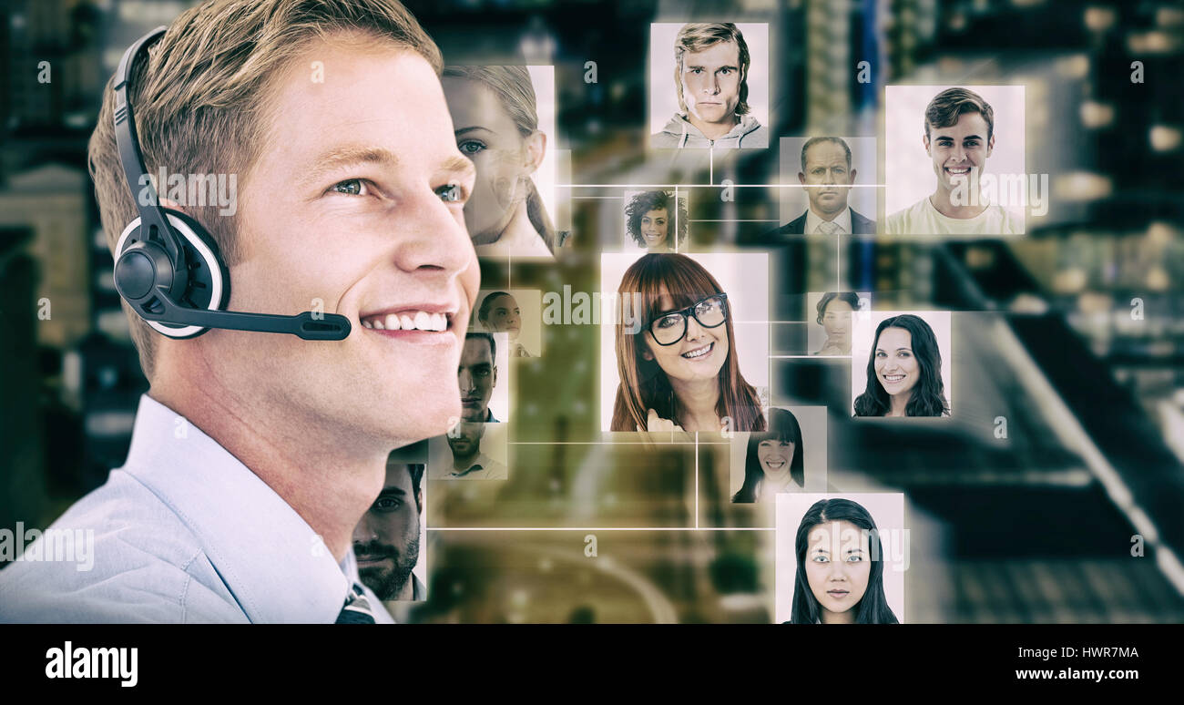 Handsome agent with headset against glowing road amidst building in ...