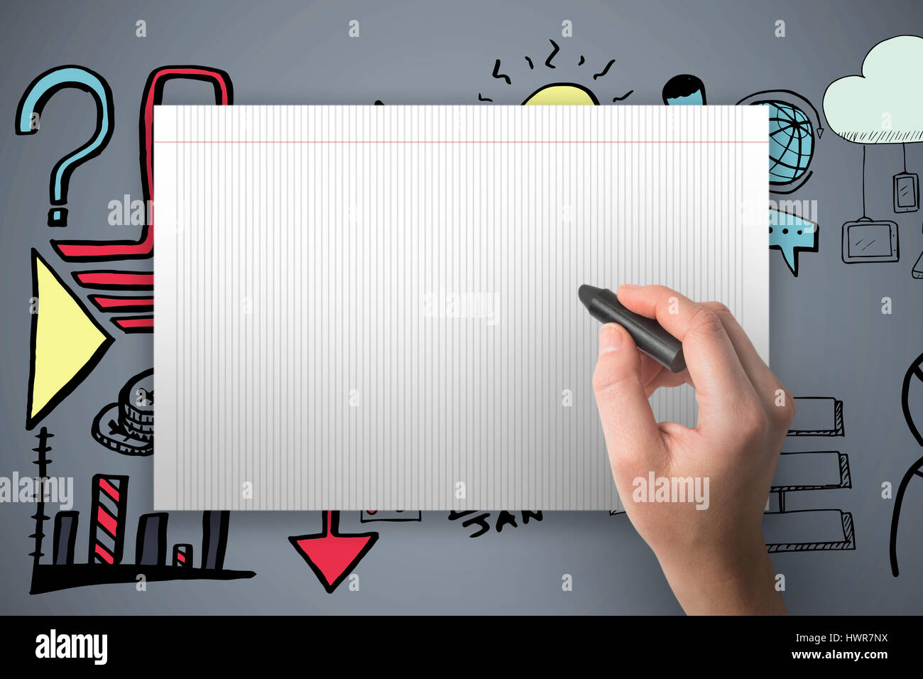 Hand holding black crayon against dark grey background Stock Photo - Alamy