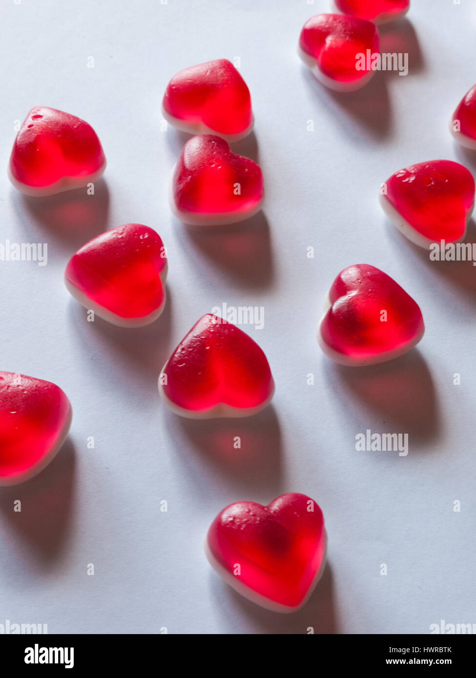 Background image of red heart chewy candy sweets Stock Photo - Alamy