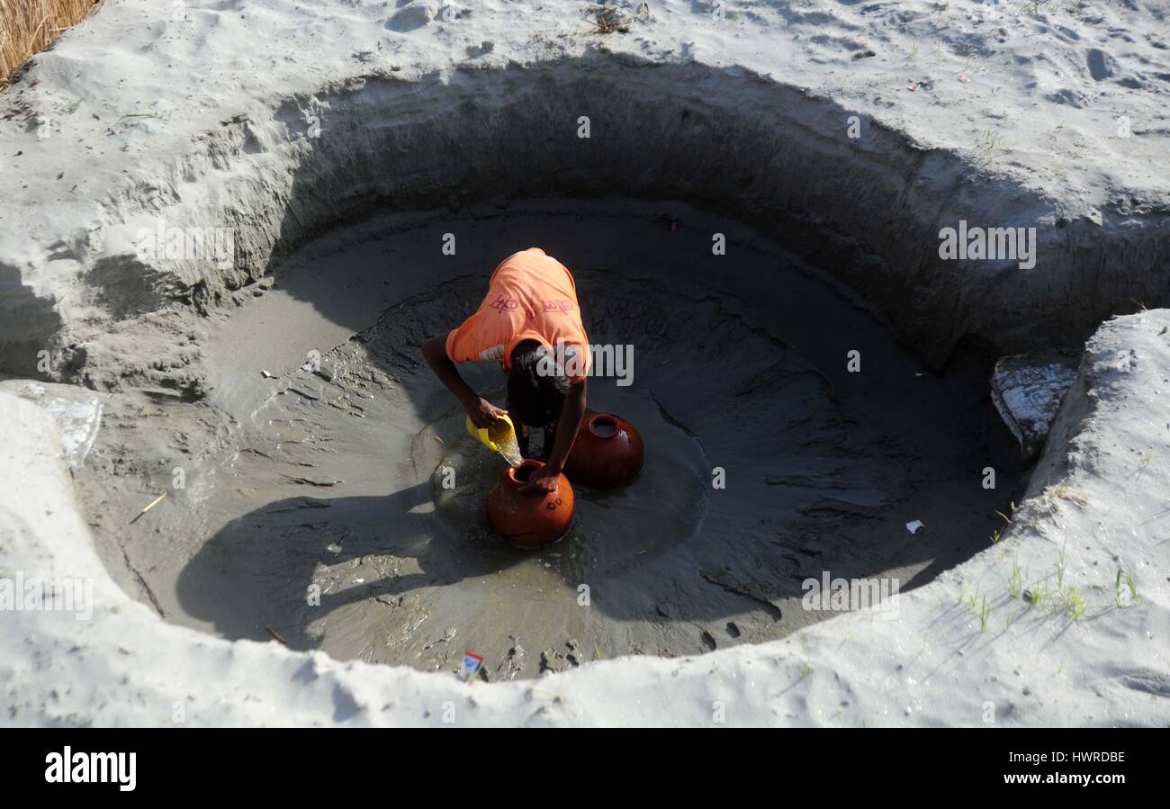 Allahabad, India. 22nd Mar, 2017. An Indian farmer carries water in ...