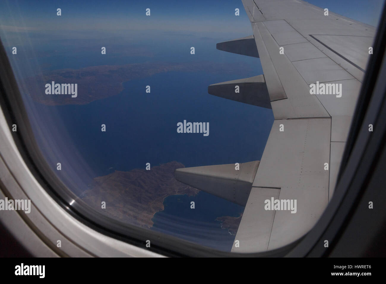 view on Greek islands through window of aircraft Stock Photo - Alamy