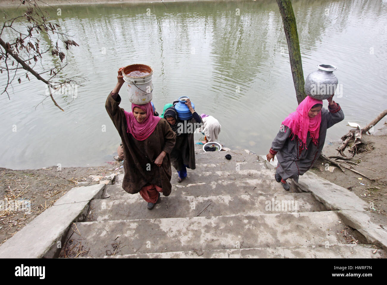 Indian women fetch water hi-res stock photography and images - Alamy