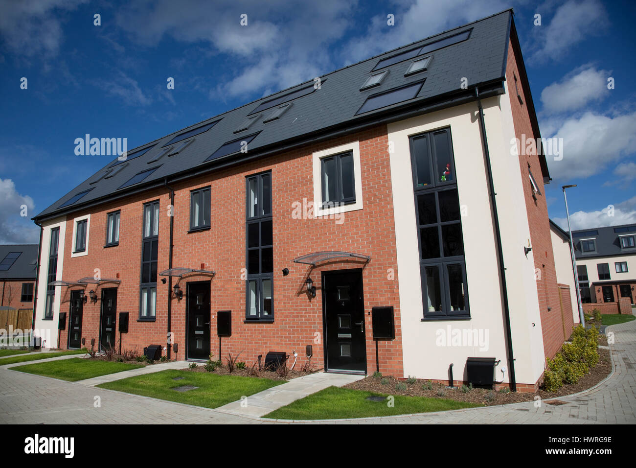 New red brick terraced houses all with solar black PV panels Persimmon ...