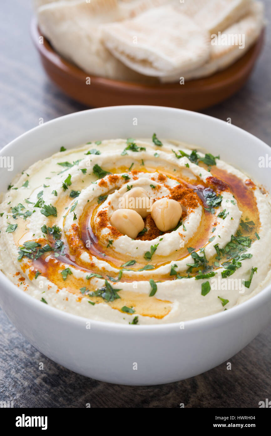 Hummus on a rustic wooden table Stock Photo - Alamy