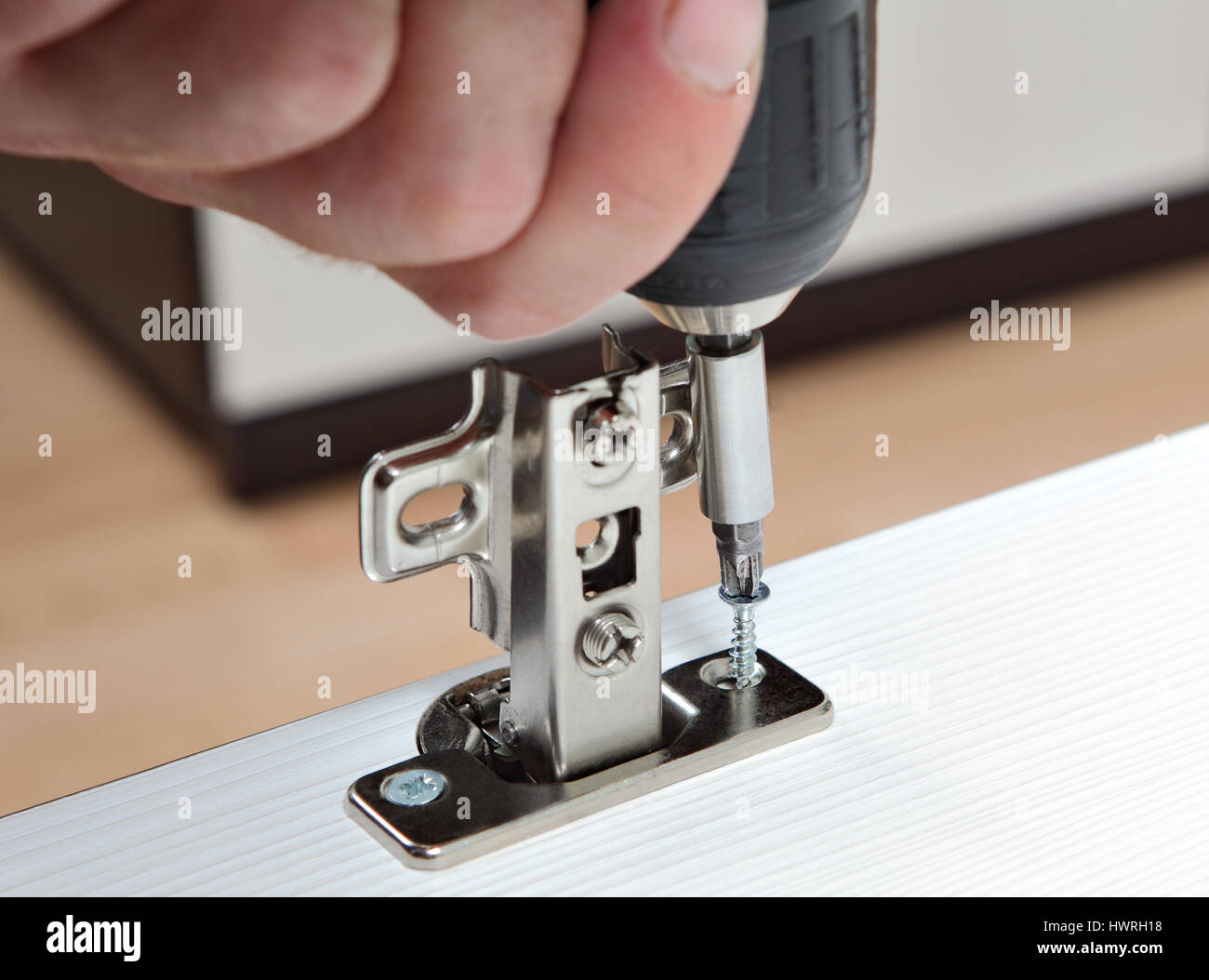 Furniture assembly, installation of door hinges, screwing screws using ...