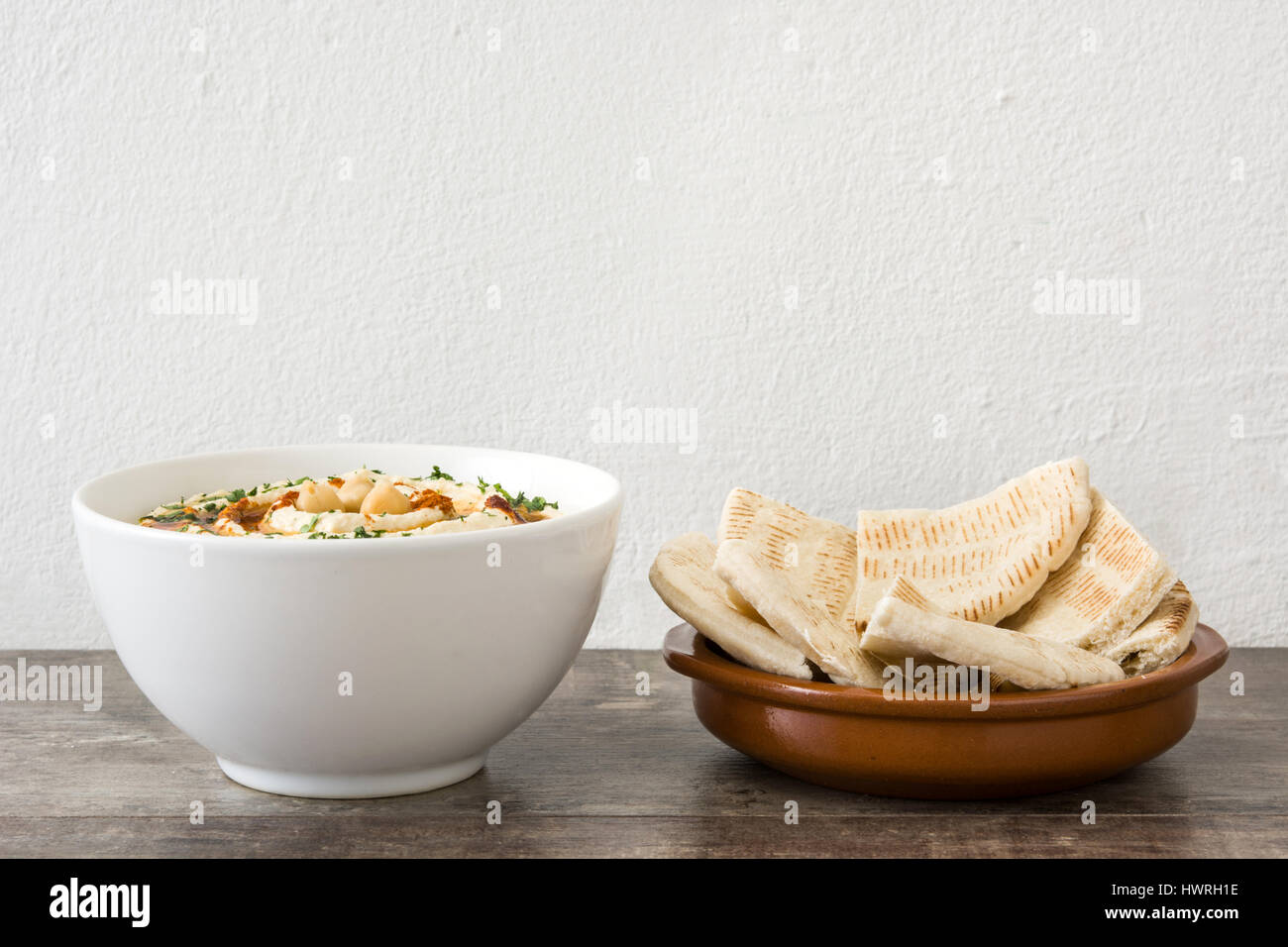 Hummus on a rustic wooden table Stock Photo - Alamy