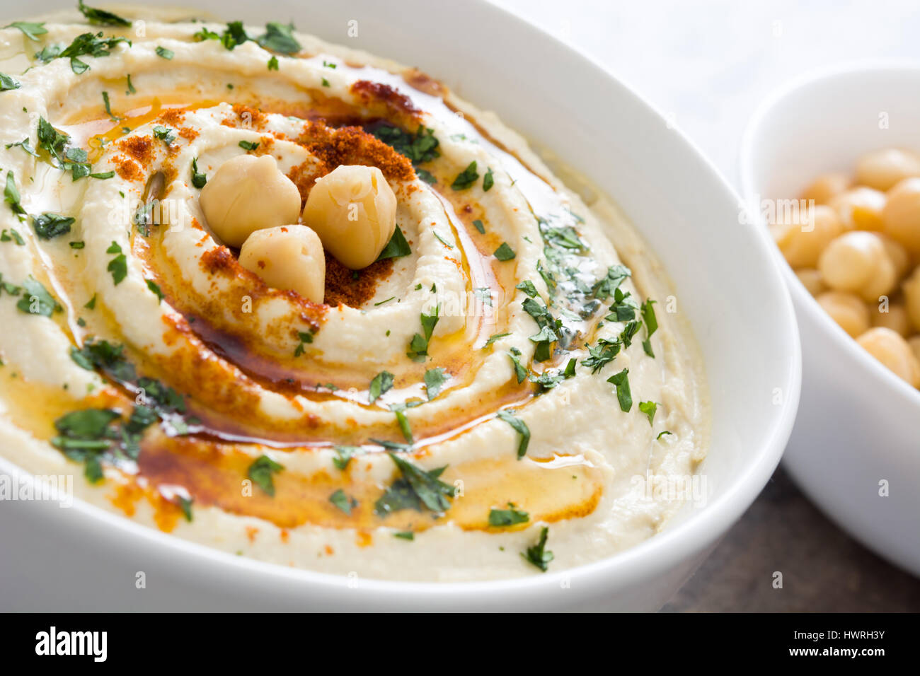 Hummus on a rustic wooden table Stock Photo - Alamy