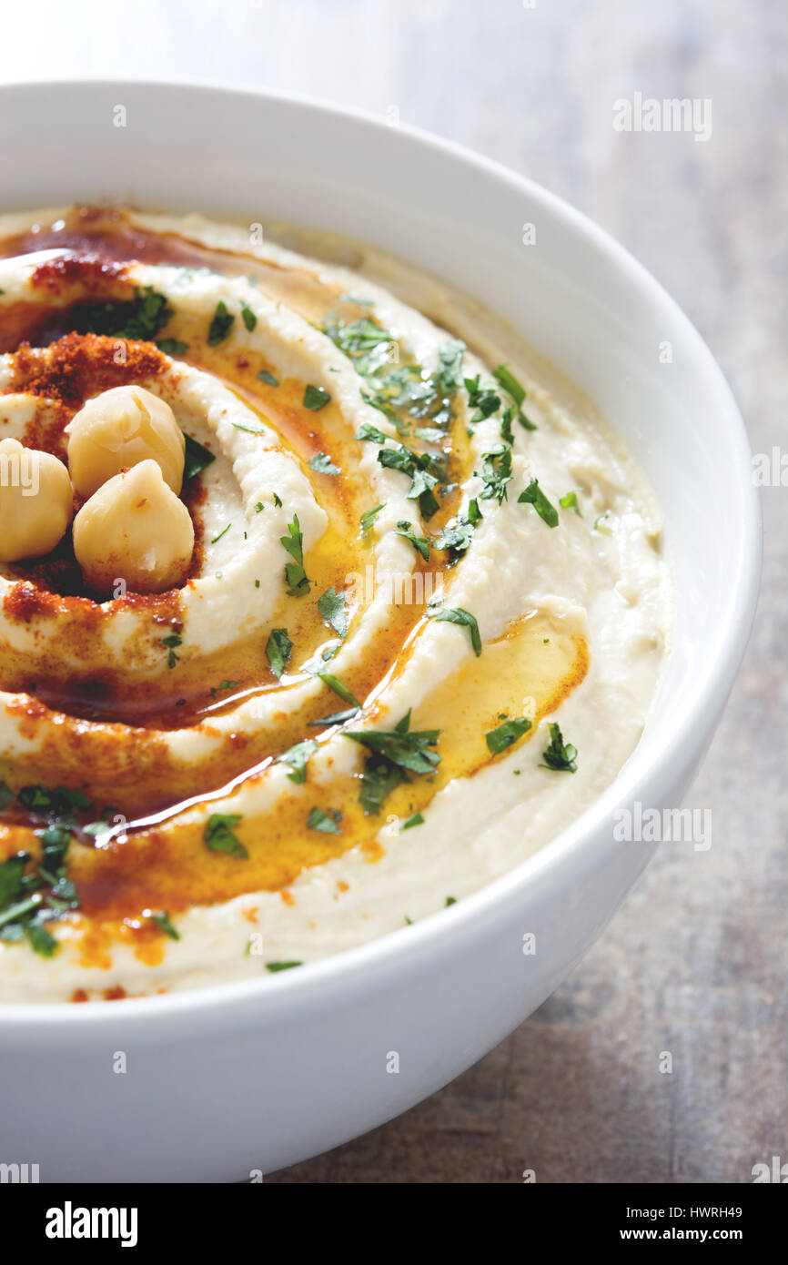 Hummus on a rustic wooden table Stock Photo - Alamy