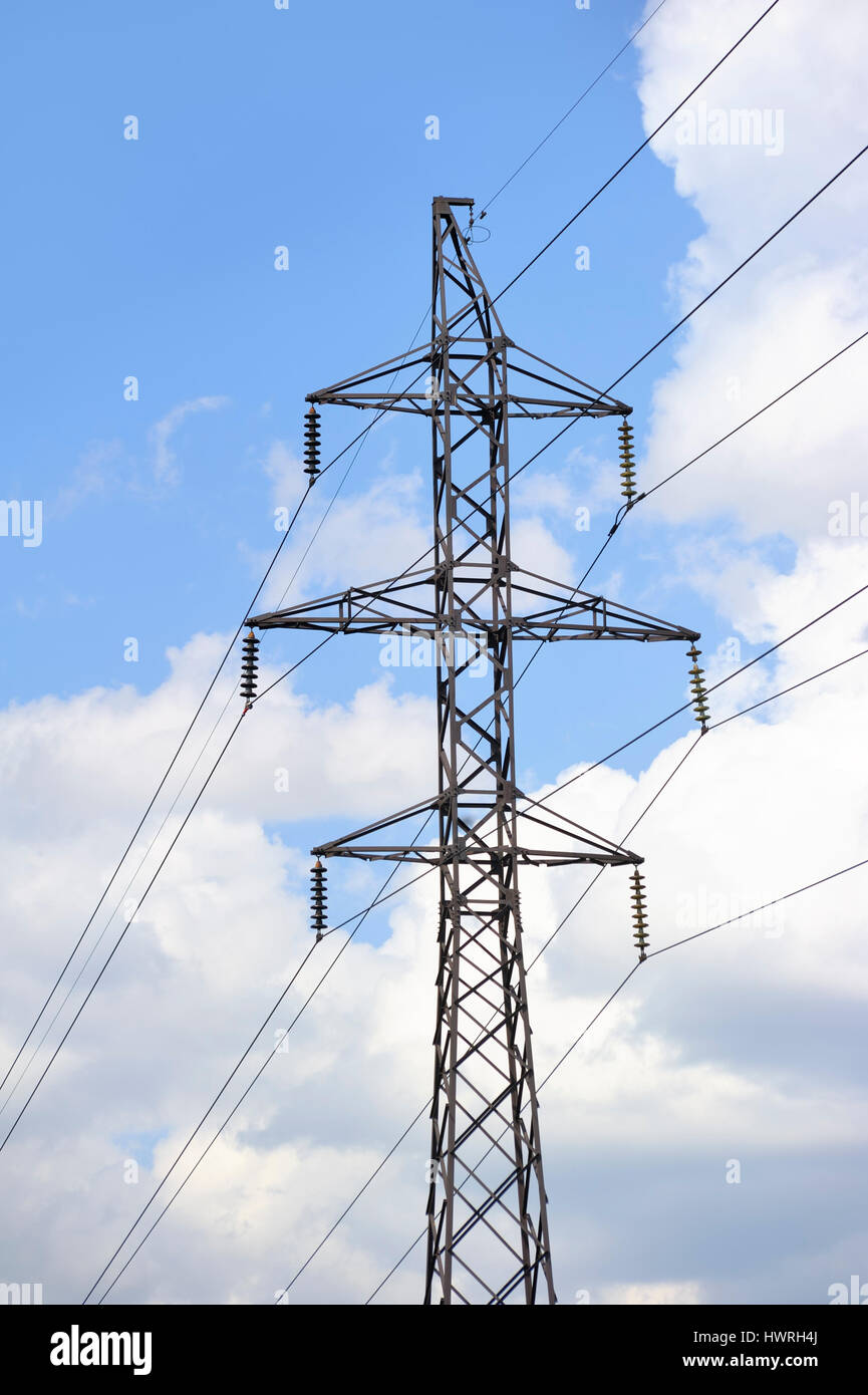 High-tension power line with clouds on background Stock Photo - Alamy