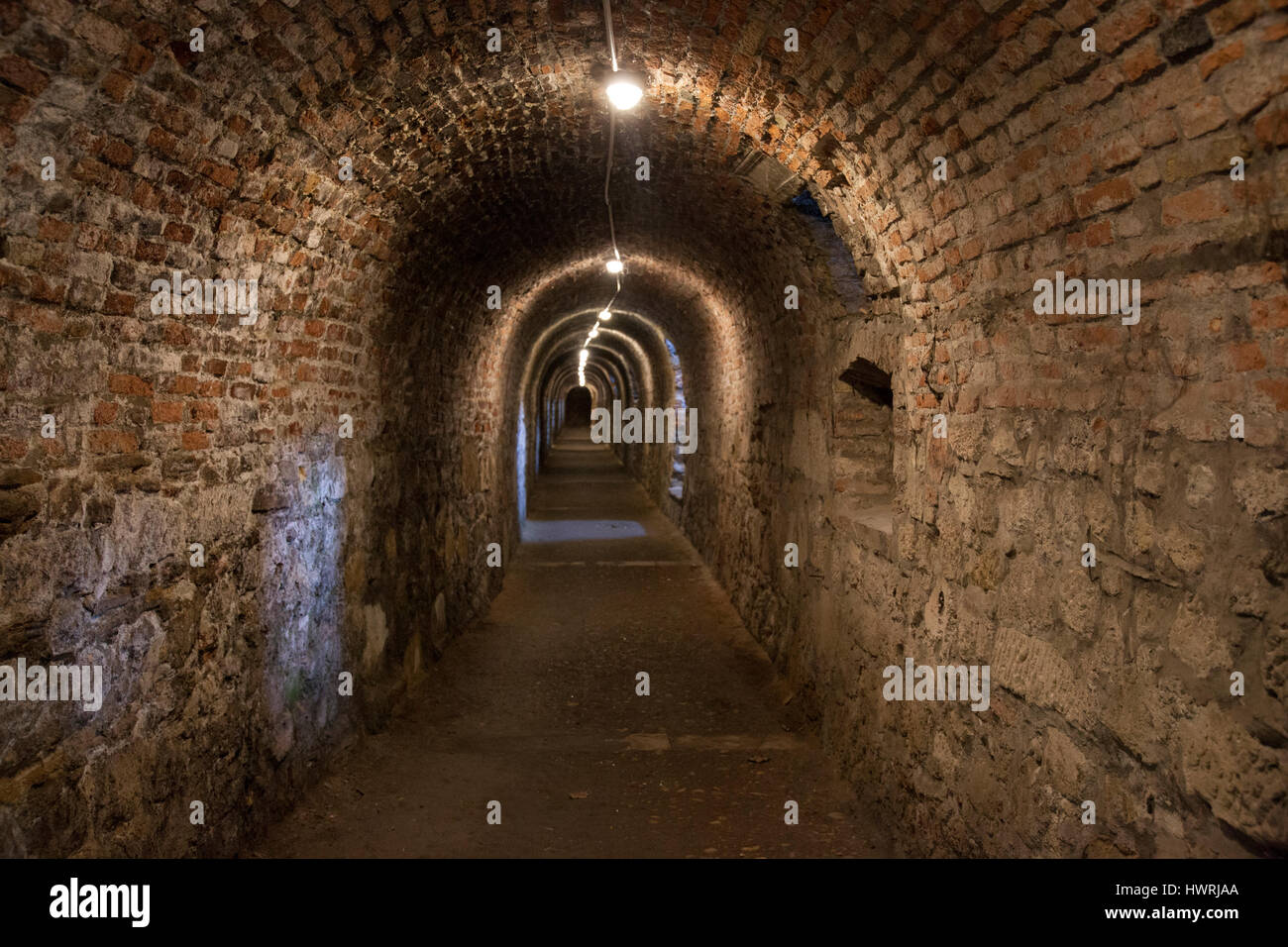 Long tunnel from stone and brick walls texture Stock Photo - Alamy