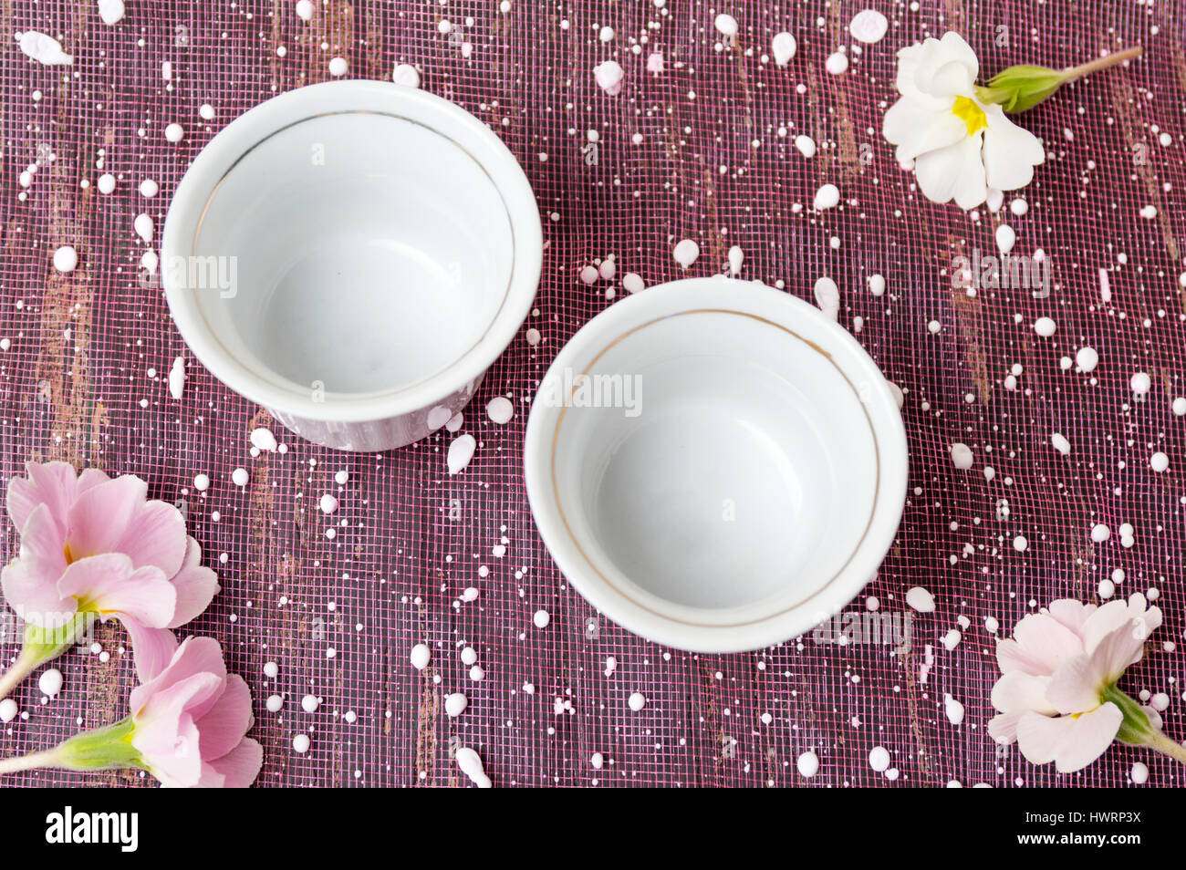 Two empty cups with pink flowers top view Stock Photo - Alamy