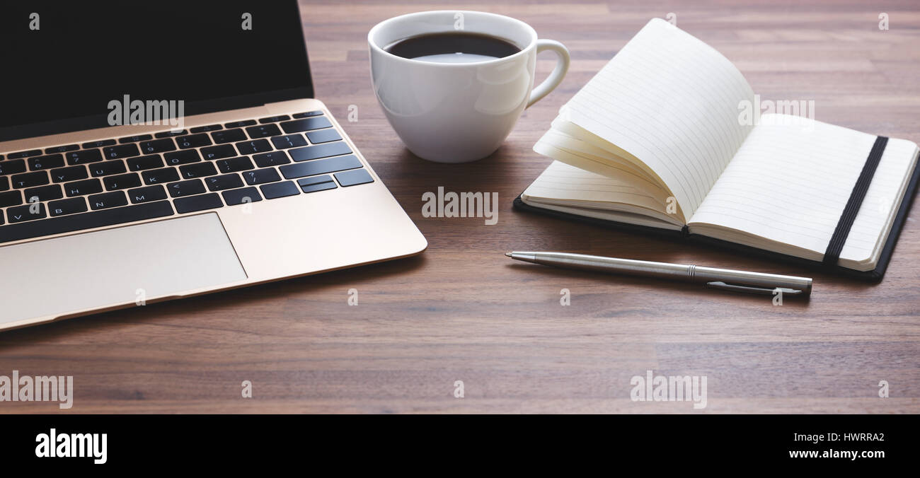 Office desk with laptop and notebook and pen Stock Photo - Alamy