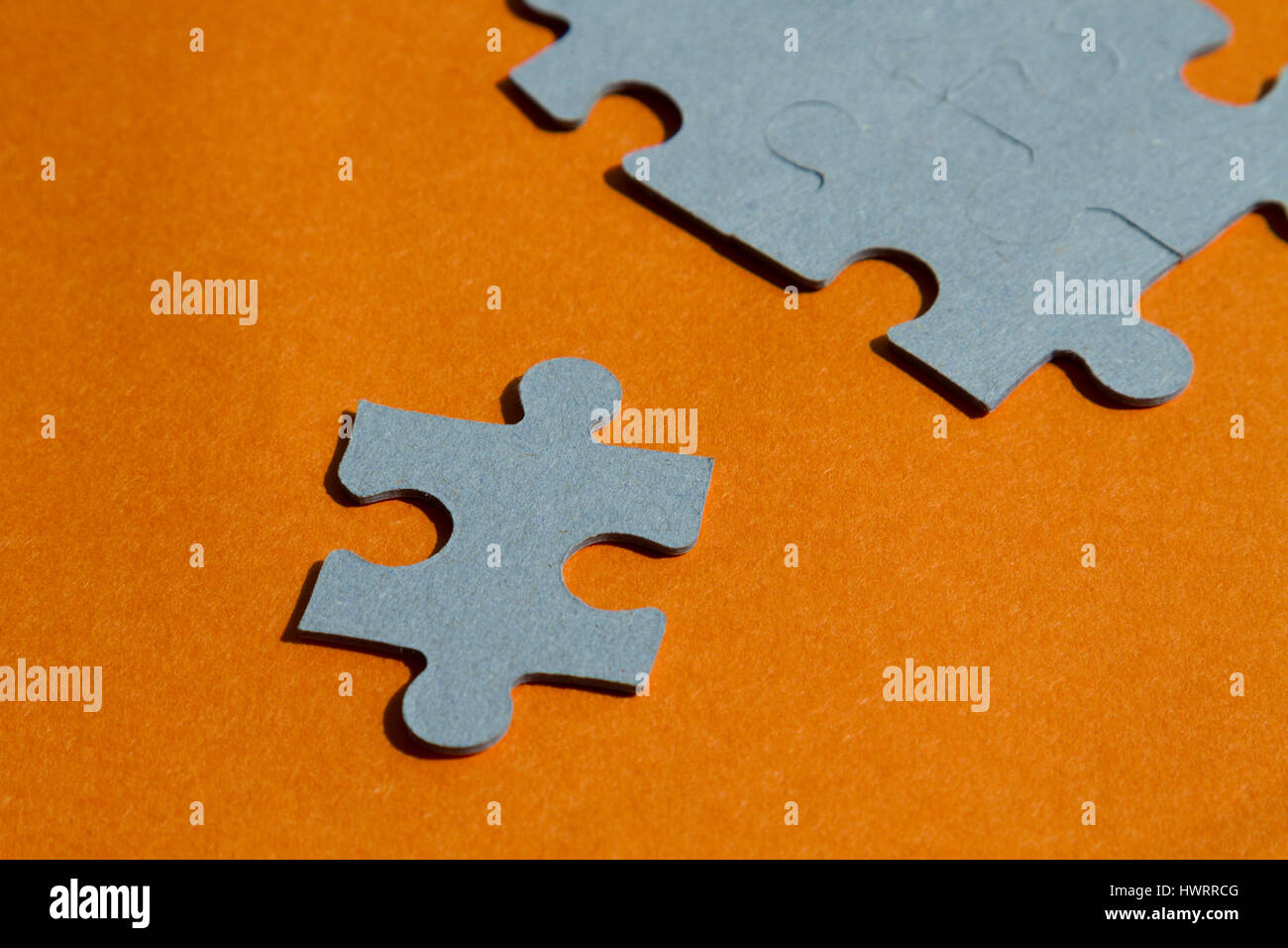 Jigsaw puzzle pieces on bright orange background, horizontal Stock ...
