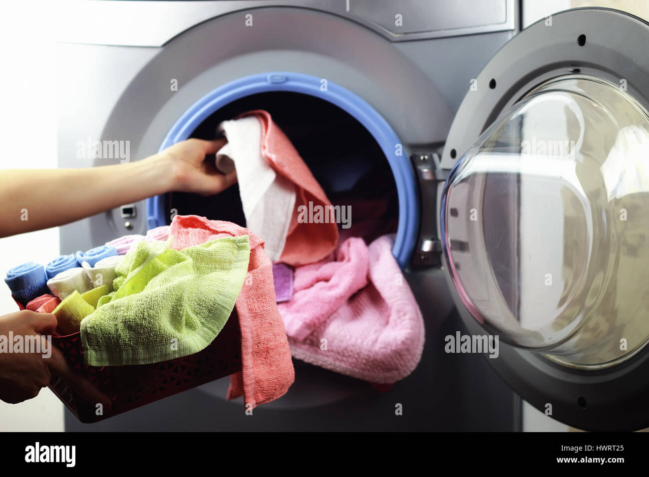 Hands loading washing machine hi-res stock photography and images - Alamy