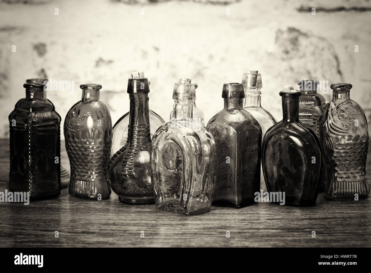 Selection of coloured glass bottles on a rustic background Stock Photo ...