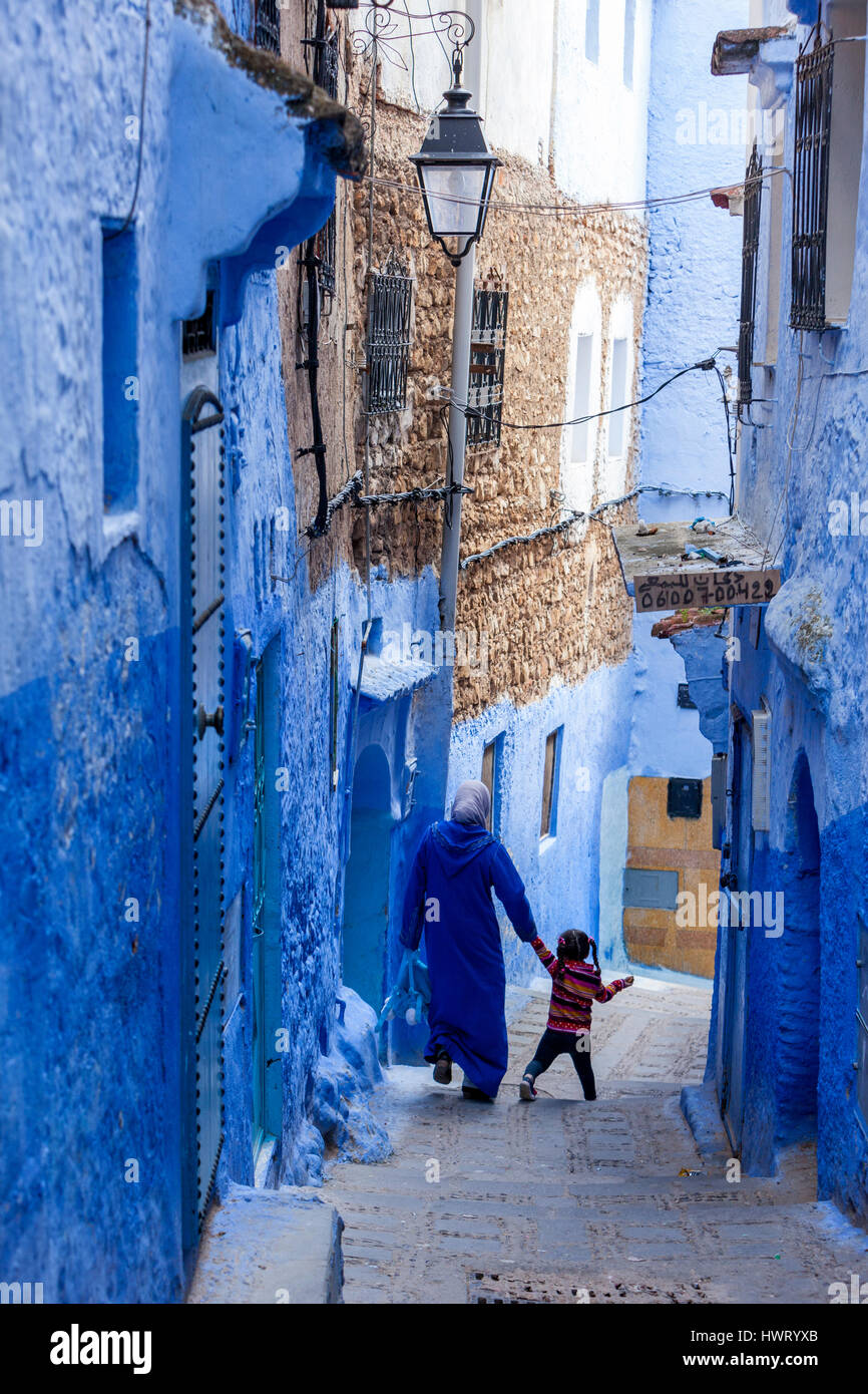 Chefchaouen, Morocco. Mother and daughter Walking down a narrow Street ...