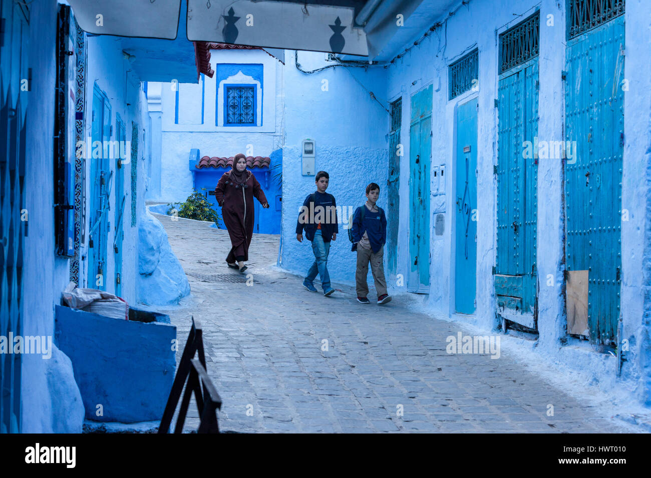 Chefchaouen, Morocco. Street Scene, Two Boys and Woman Walking Stock ...