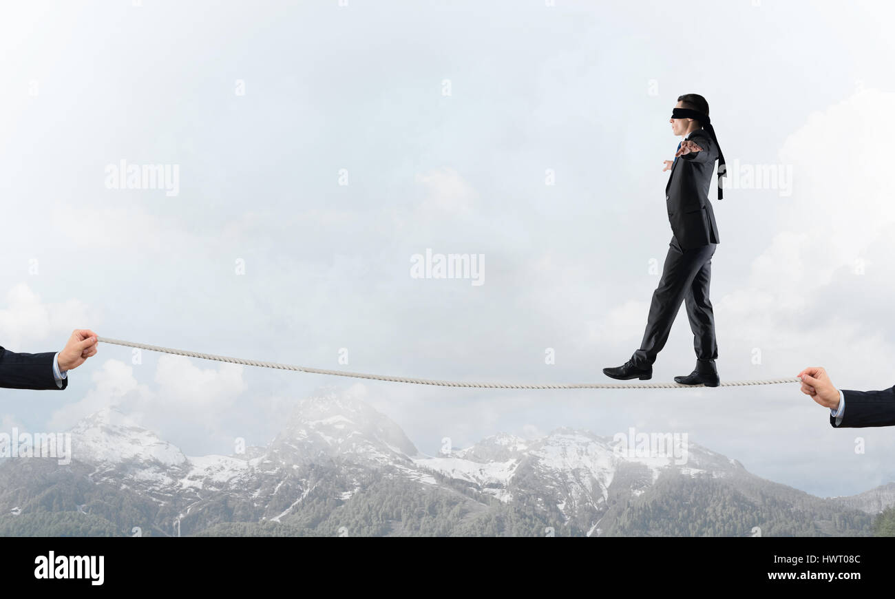 Business concept of risk support and assistance with man balancing on ...