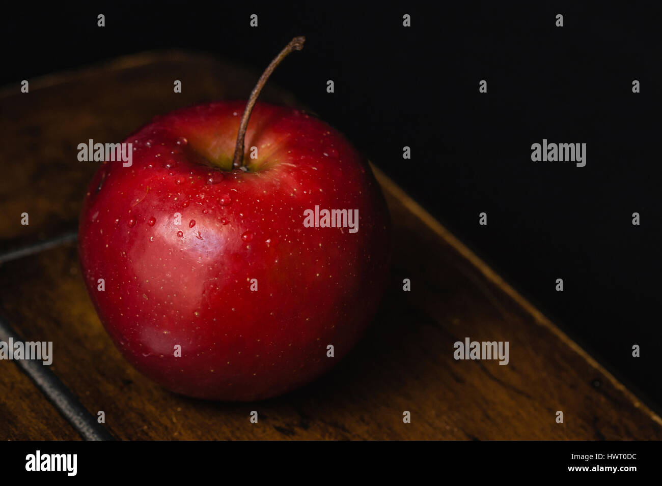 High angle close-up of wet apple on wooden table Stock Photo - Alamy