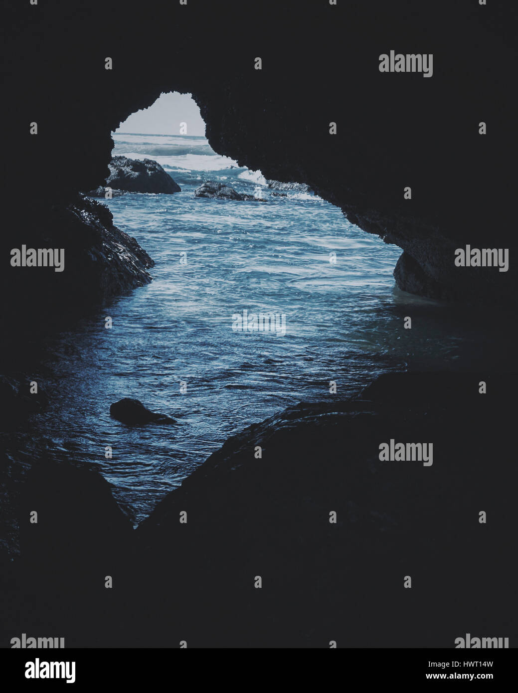 High angle view of sea seen through cave Stock Photo - Alamy